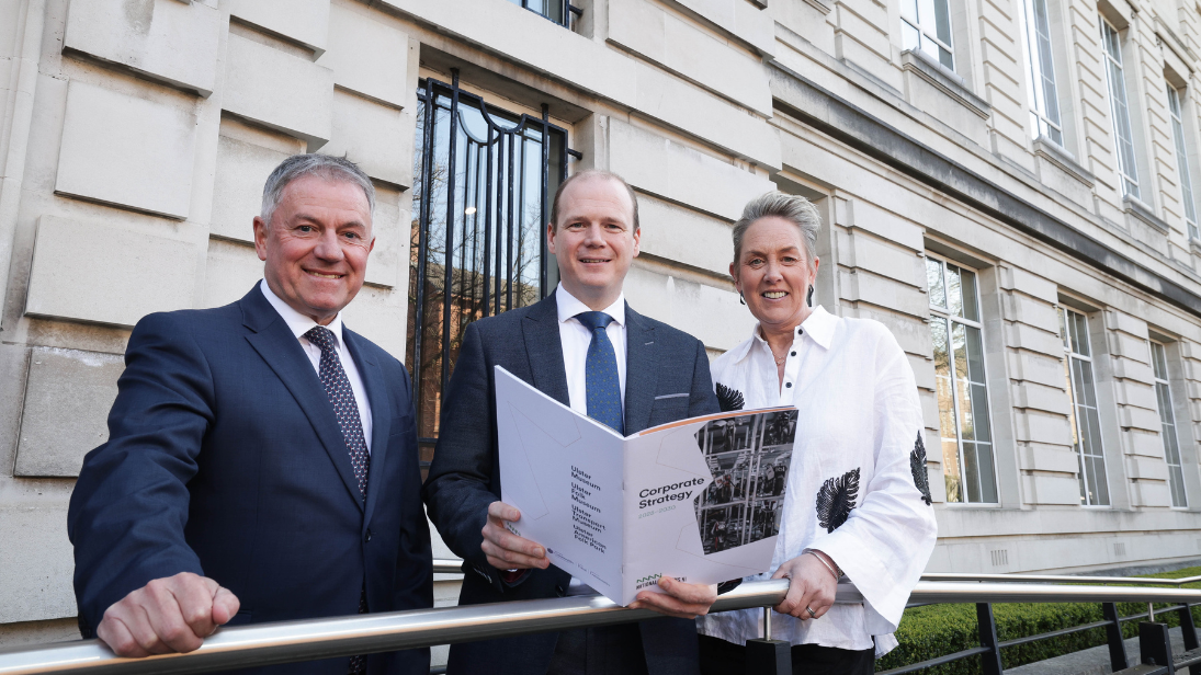 Three people standing beside a railing outside the Ulster Museum, the ...