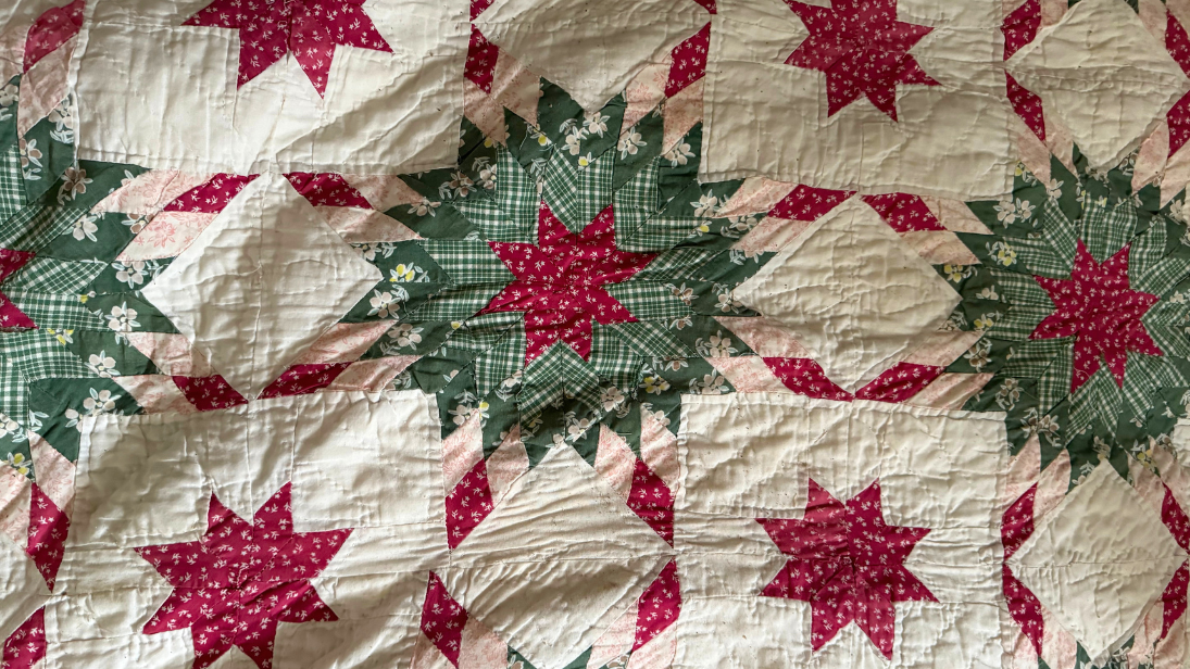 Close up of a patchwork quilt in the folk park collections